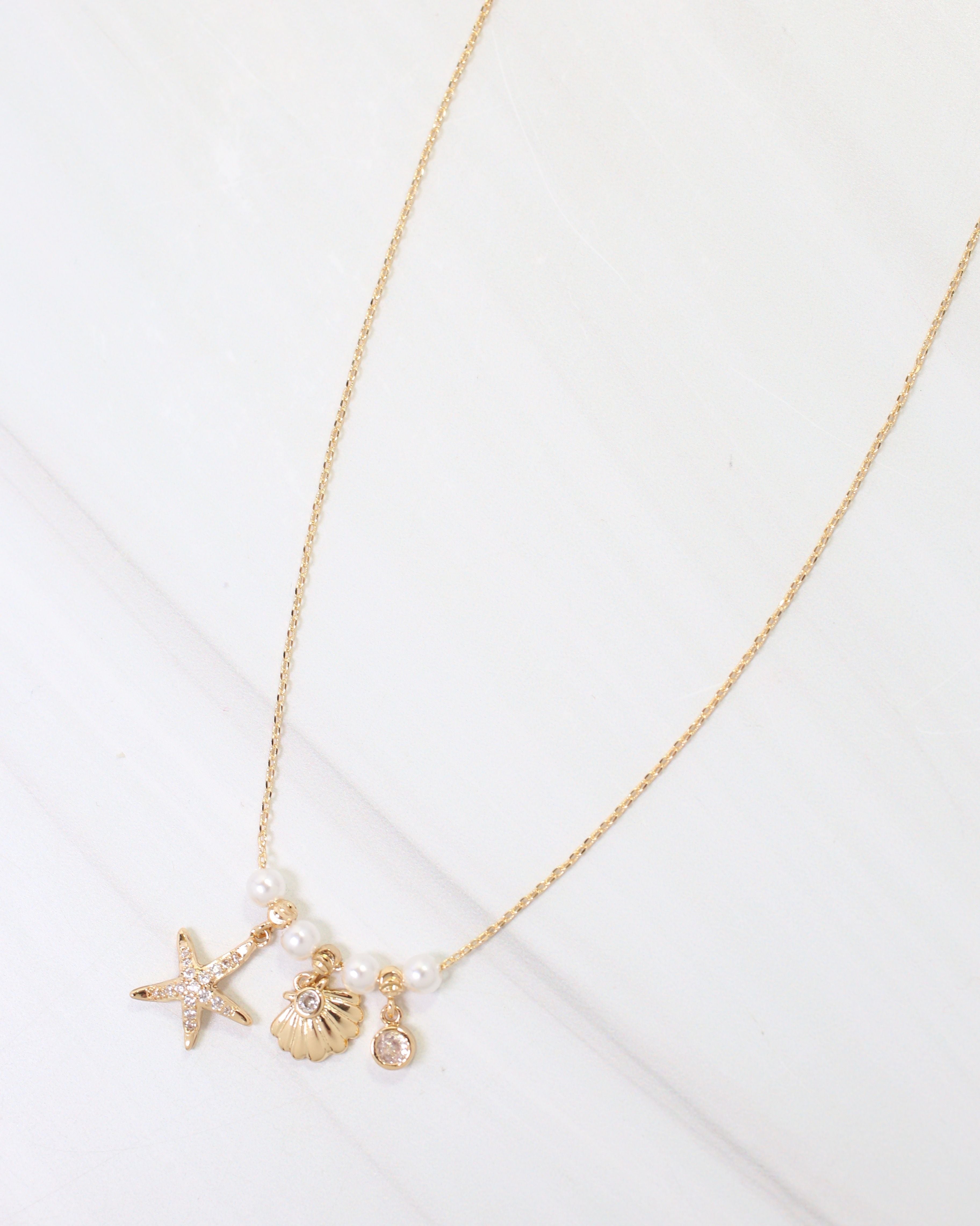 Whitman Starfish and Shell Charm Necklace Gold – Caroline Hill Wholesale